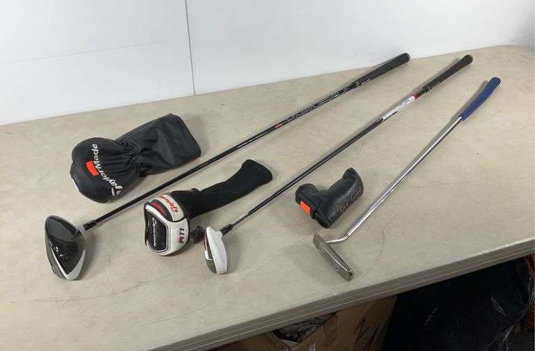 Three golf clubs with sleeves, Taylor Made M2 10.5, Taylor Made R11 ...