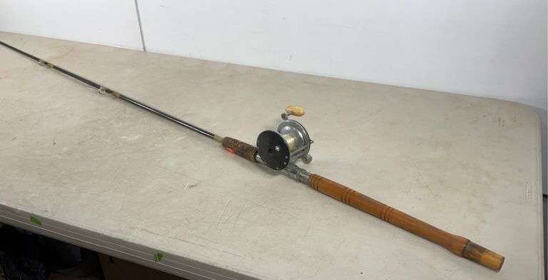 Unmarked deep sea fishing rod with Penn Long Beach reel, wood handled ...