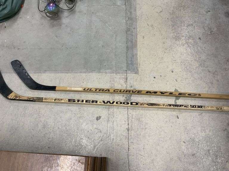 Hockey sticks, one is signed - Legacy Auction Company