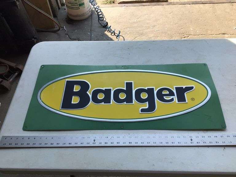 Metal badger sign - Legacy Auction Company