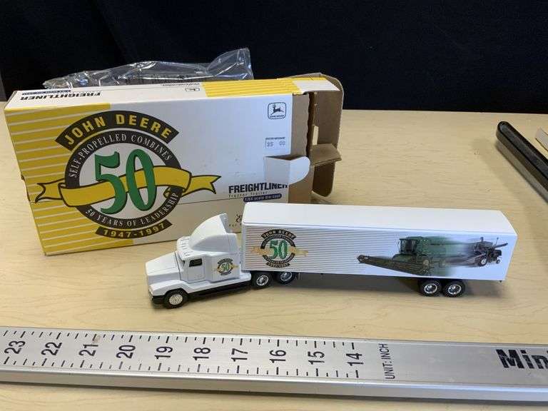 John Deere Freightliner tractor trailer - Legacy Auction Company