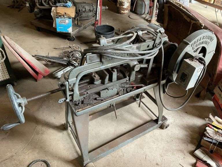 Robertson’s economy power hacksaw. On stand with - Legacy Auction Company
