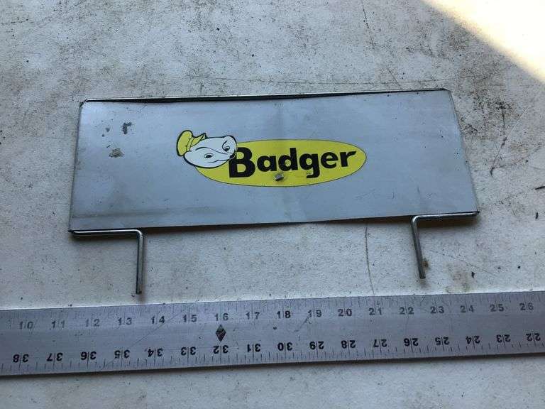 Vintage metal badger sign - Legacy Auction Company