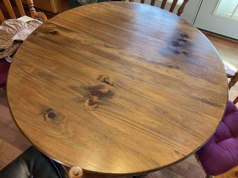 4 foot round table and four chairs - Legacy Auction Company