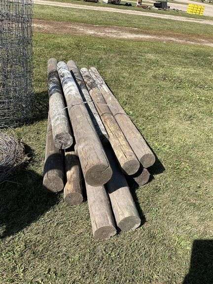 11- 8’ wooden fence posts - Legacy Auction Company