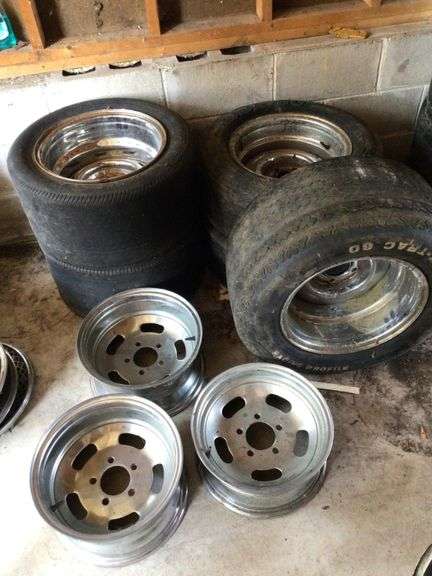 Misc 14 and 15 inch chrome rims and tires - Legacy Auction Company