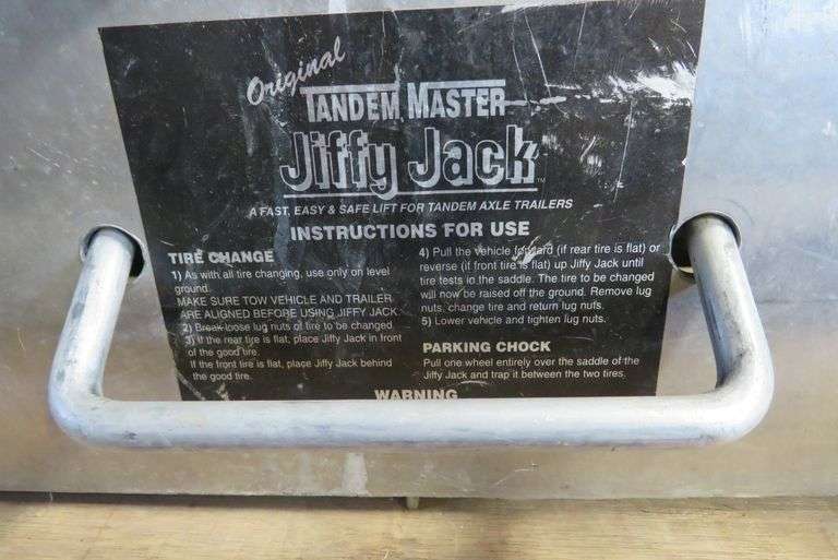 ALUMINUM JIFFY JACK RAMP AND A 4 WAY TIRE IRON - McPherson Auction & Realty