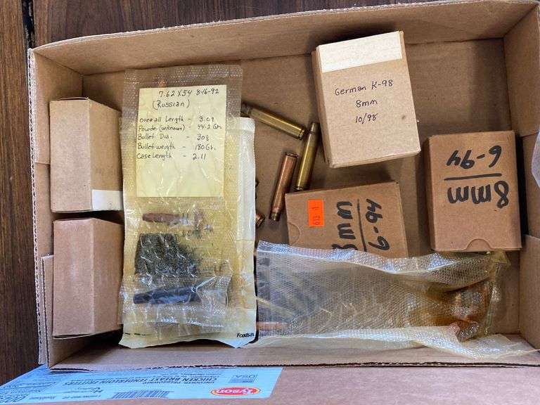 Six boxes of 8mm rounds, various shell casings and bags of bullet ...