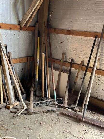 Spud bars, axe, shovels and picks contents of corner as shown in ...