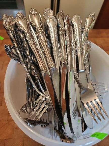 Stainless steel flatware in Tupperware bowl - Metzger Property Services LLC