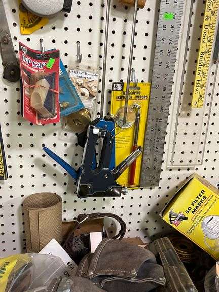 Levels, straight edge, t square, contents of wall and on top of bench ...