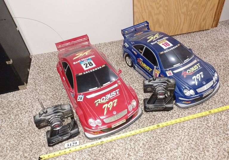 Pair of large remote control race cars and controllers. - Mark Van Hook ...