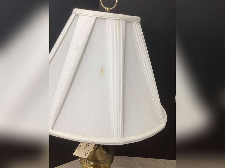 One pair of brass table lamps, 32 inches tall. One of the shades has ...