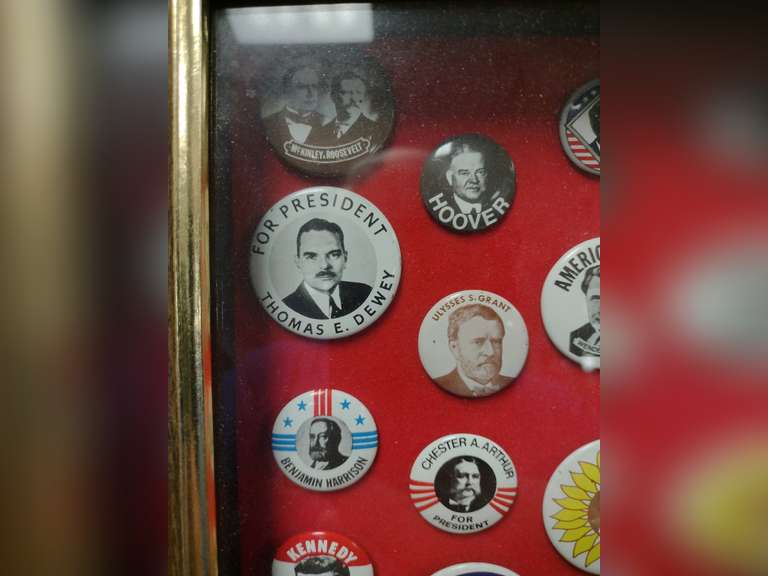 Political pinback buttons in display case.