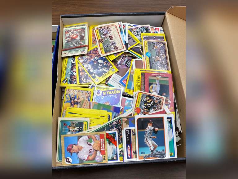 Two shoe boxes full of baseball, football and basketball cards ...