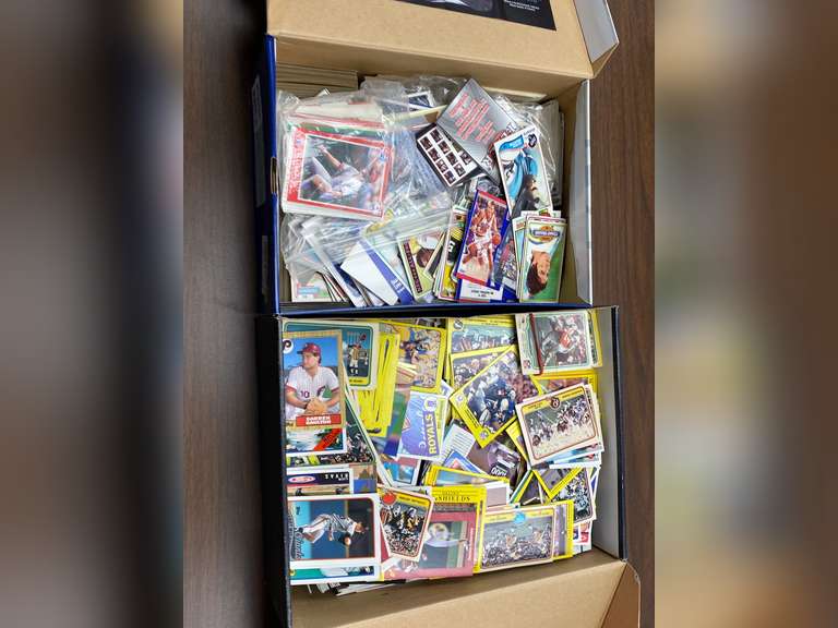 Two shoe boxes full of baseball, football and basketball cards ...