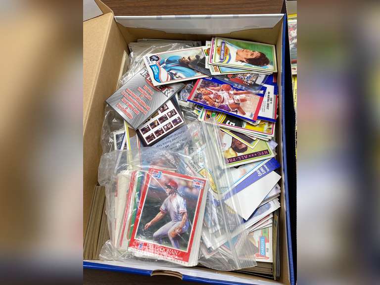 Two shoe boxes full of baseball, football and basketball cards ...