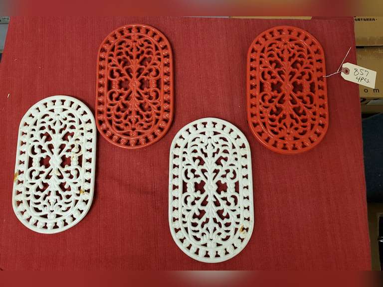 4 Red and white cast iron trivets