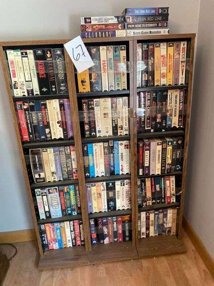 Huge lot of VHS tapes with storage rack - Parrott Marketing Group