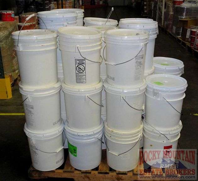 Assorted white buckets full of assorted honey, sesame & other ...