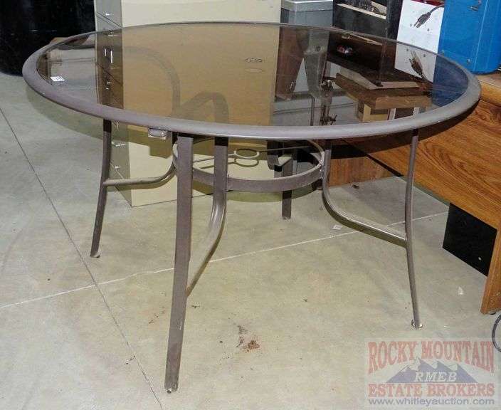 48" round glass top patio table with umbrella hole. Glass is chipped ...