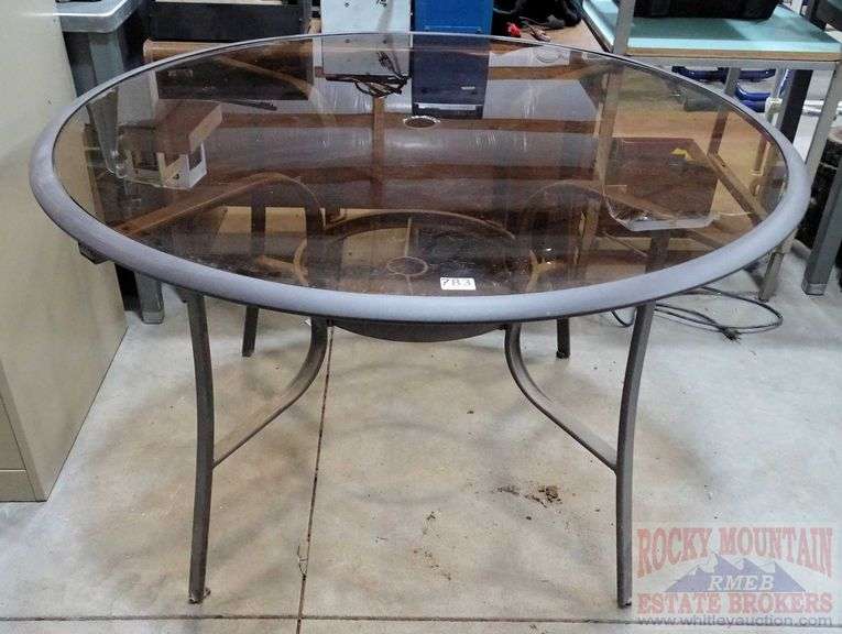 48" round glass top patio table with umbrella hole. Glass is chipped ...