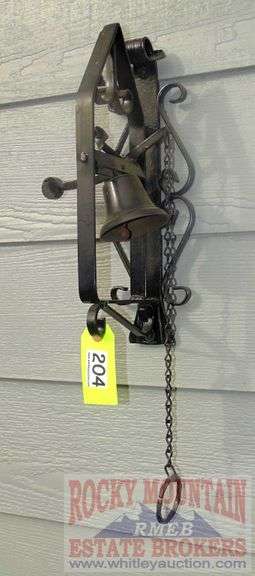Neat wrought iron wall mount bell. - Rocky Mountain Estate Brokers Inc.