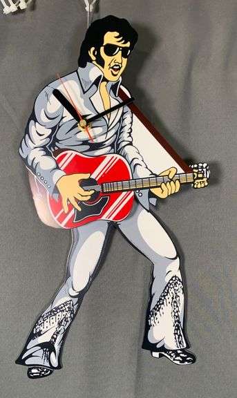 Neat new, "Elvis" swinging legs clock. - Rocky Mountain Estate Brokers Inc.