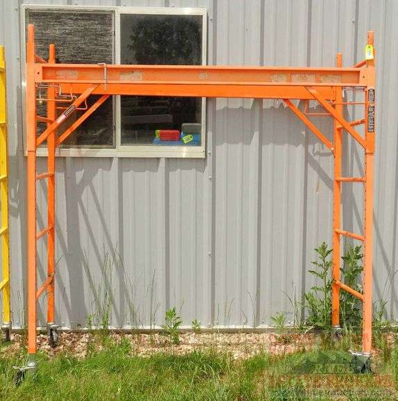 Orange scaffold w/ 4 casters. - Rocky Mountain Estate Brokers Inc.