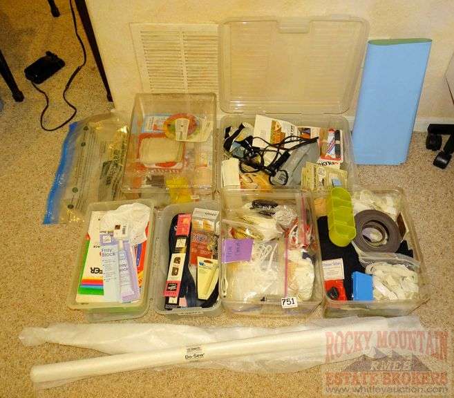 Zippers, elastic and lots of assorted sewing notions in plastic storage ...