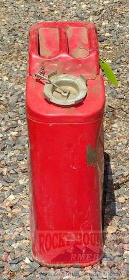 Red Jerry can, dented. - Rocky Mountain Estate Brokers Inc.