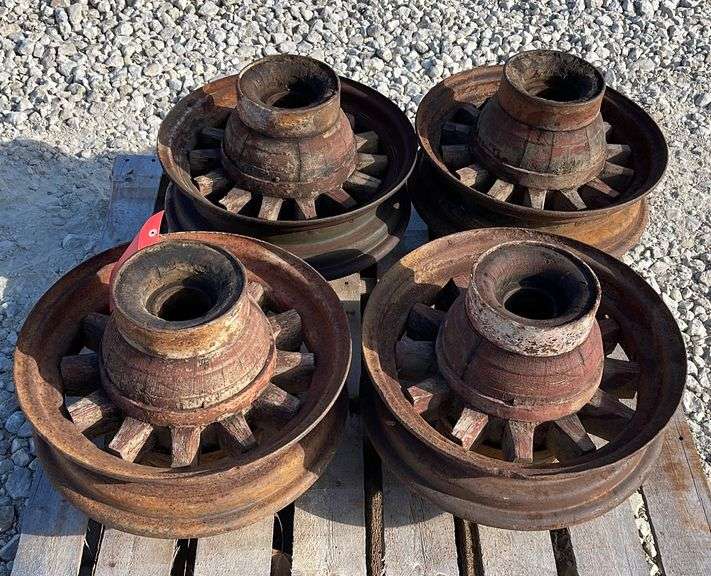 4 antique wagon wheels with wooden centers - Schneider Auctioneers LLC