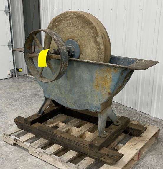 Large antique grindstone w/ cast iron tank - Schneider Auctioneers LLC