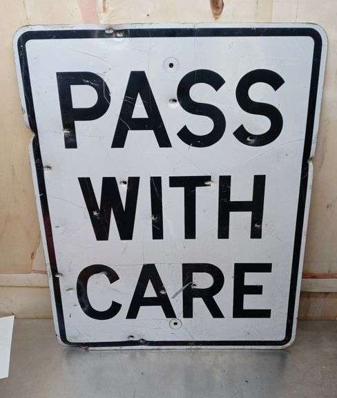 Pass With Care Road Sign with Real Bullet Holes - Sherwood Auctions
